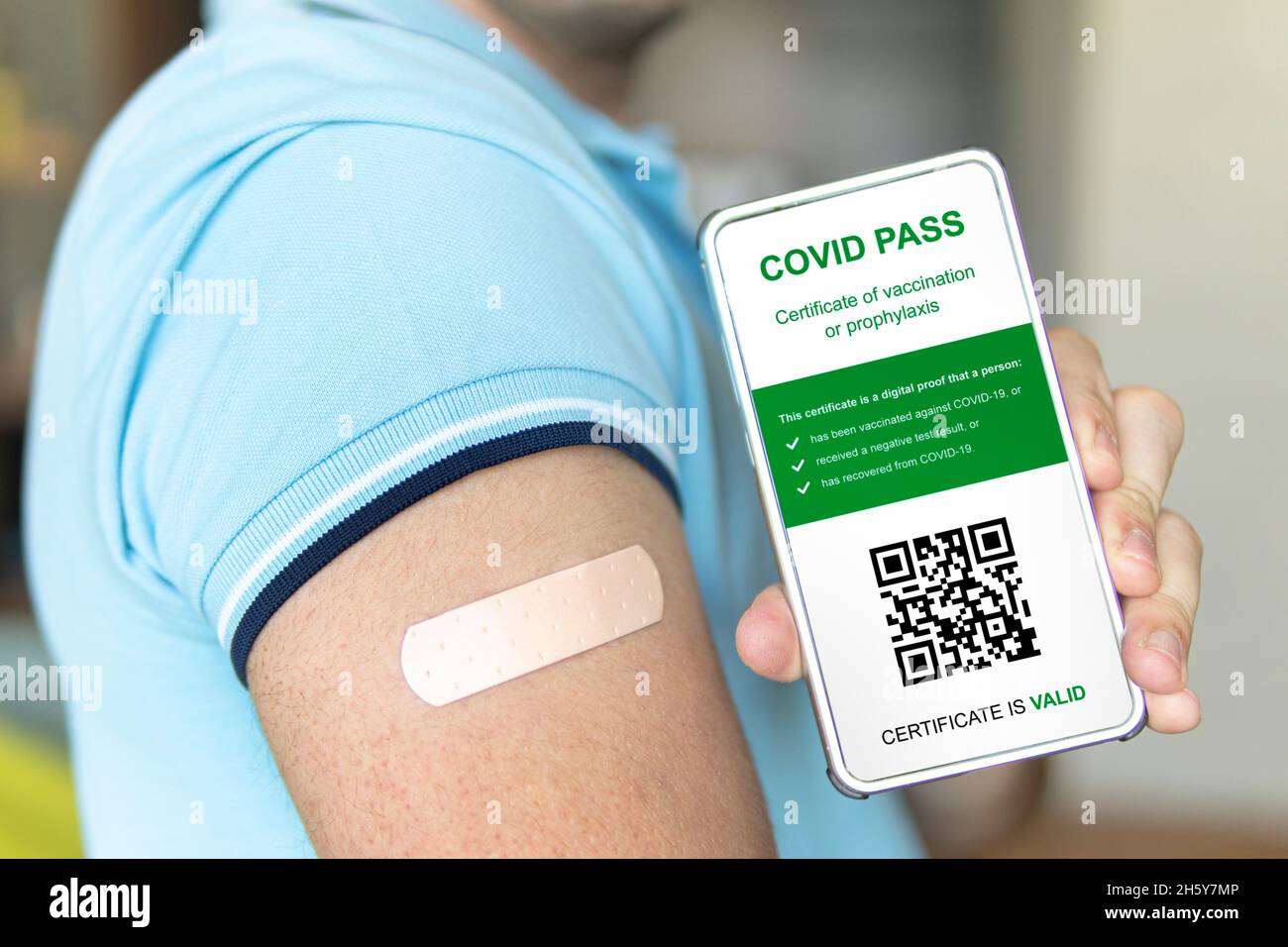 The man proves that he is vaccinated by showing a shoulder with a ...