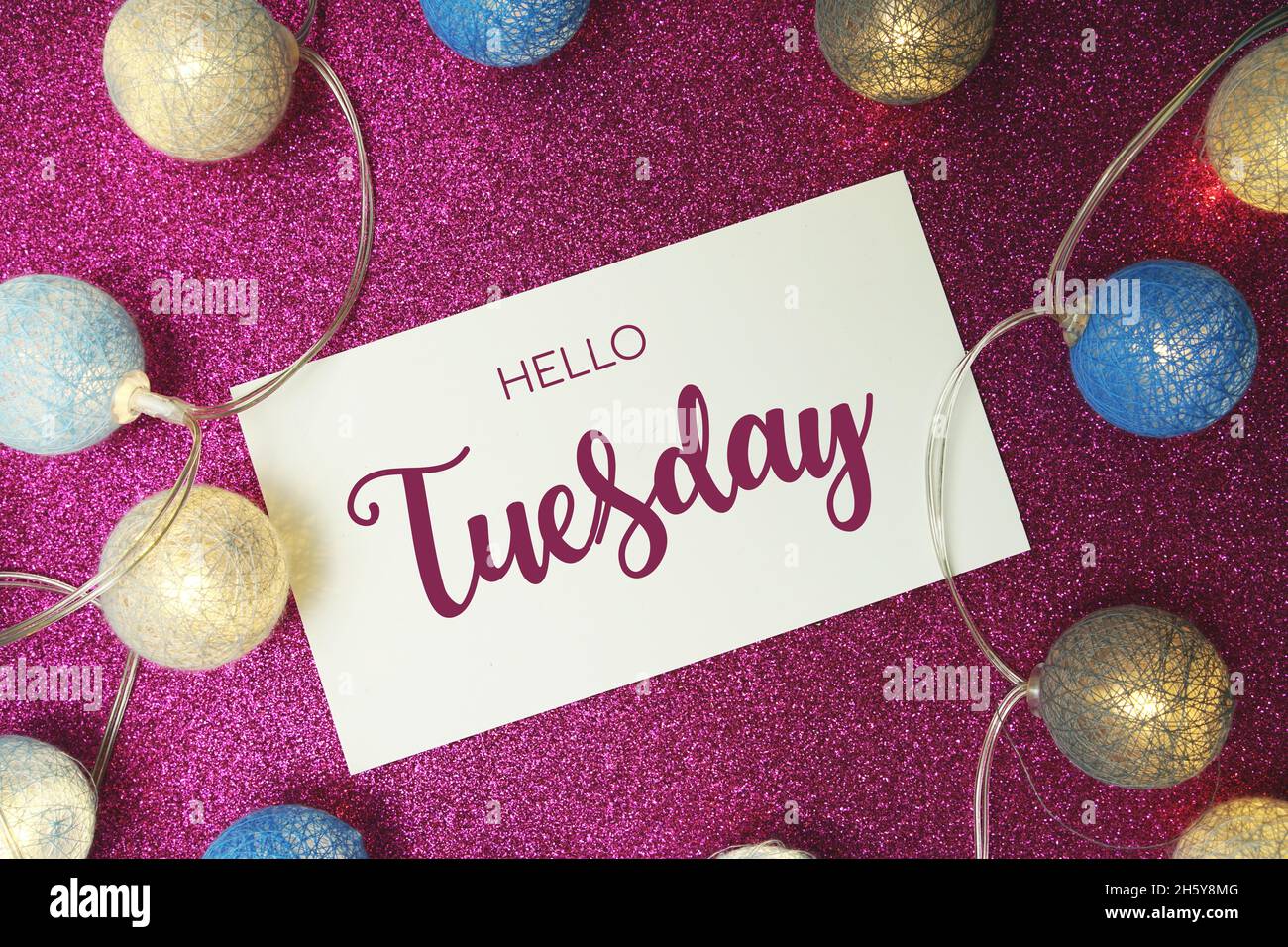 Hello Tuesday typography text with LED cotton ball on pink glitter ...