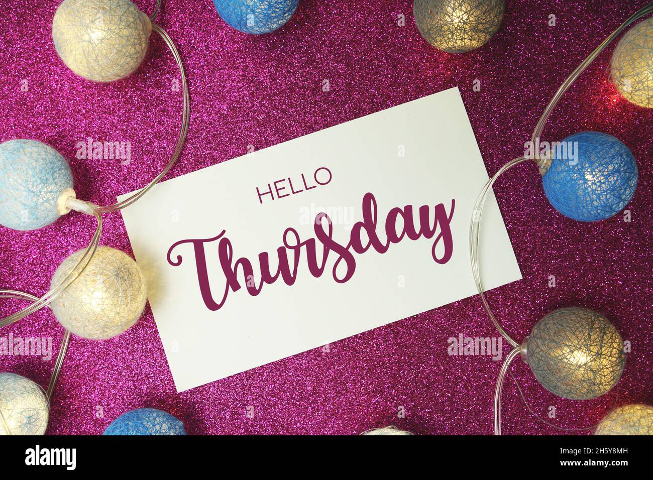 Hello Thursday typography text with LED cotton ball on pink glitter ...