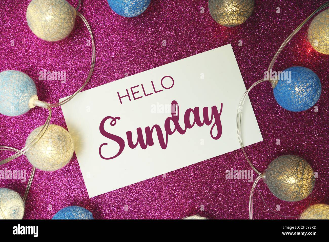 Hello Sunday typography text with LED cotton ball on pink glitter ...