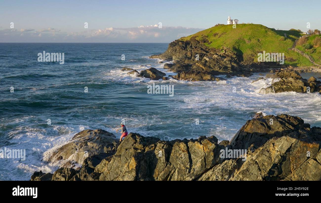 fisherman rock fishing at tacking point lighthouse Stock Photo - Alamy