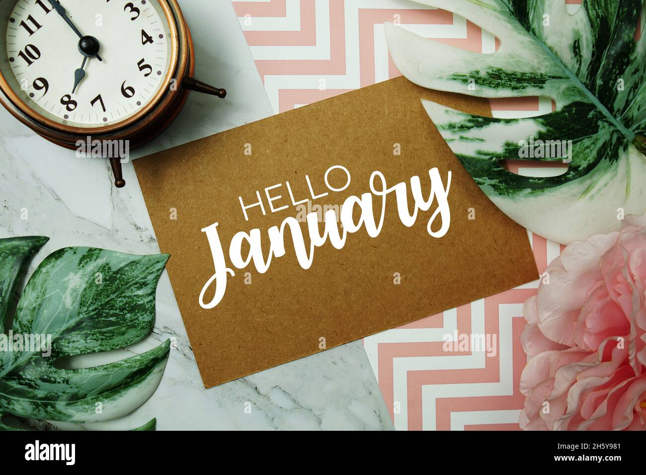 Hello January typography text on paper card with alarm clock and ...