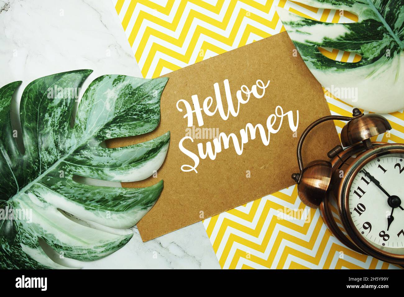Hello Summer typography text on paper card with alarm clock and ...
