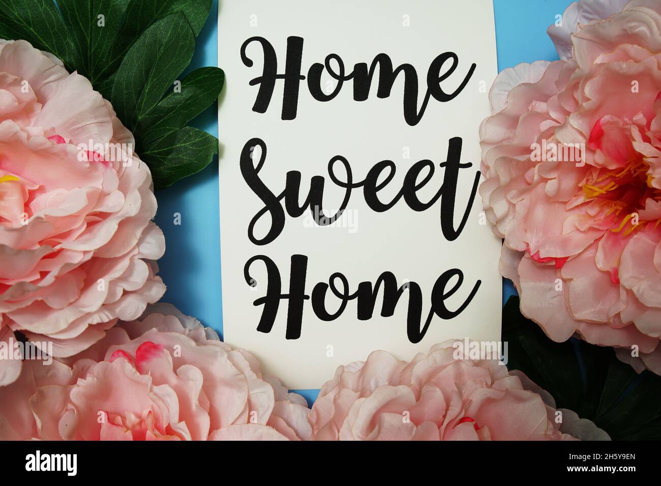 Home Sweet Home typography text with peony flowers on blue background ...