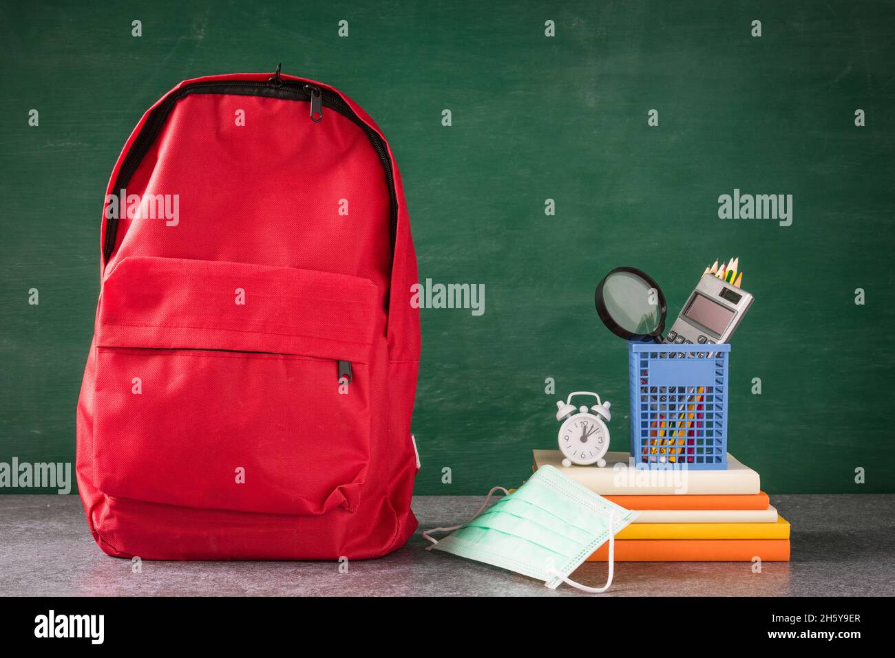 Front school backpack and accessories with face mask protect on desk at ...