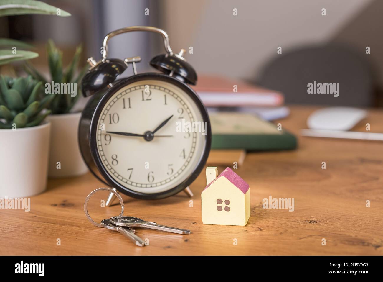 Model house on construction plan for house building, keys, red alarm ...