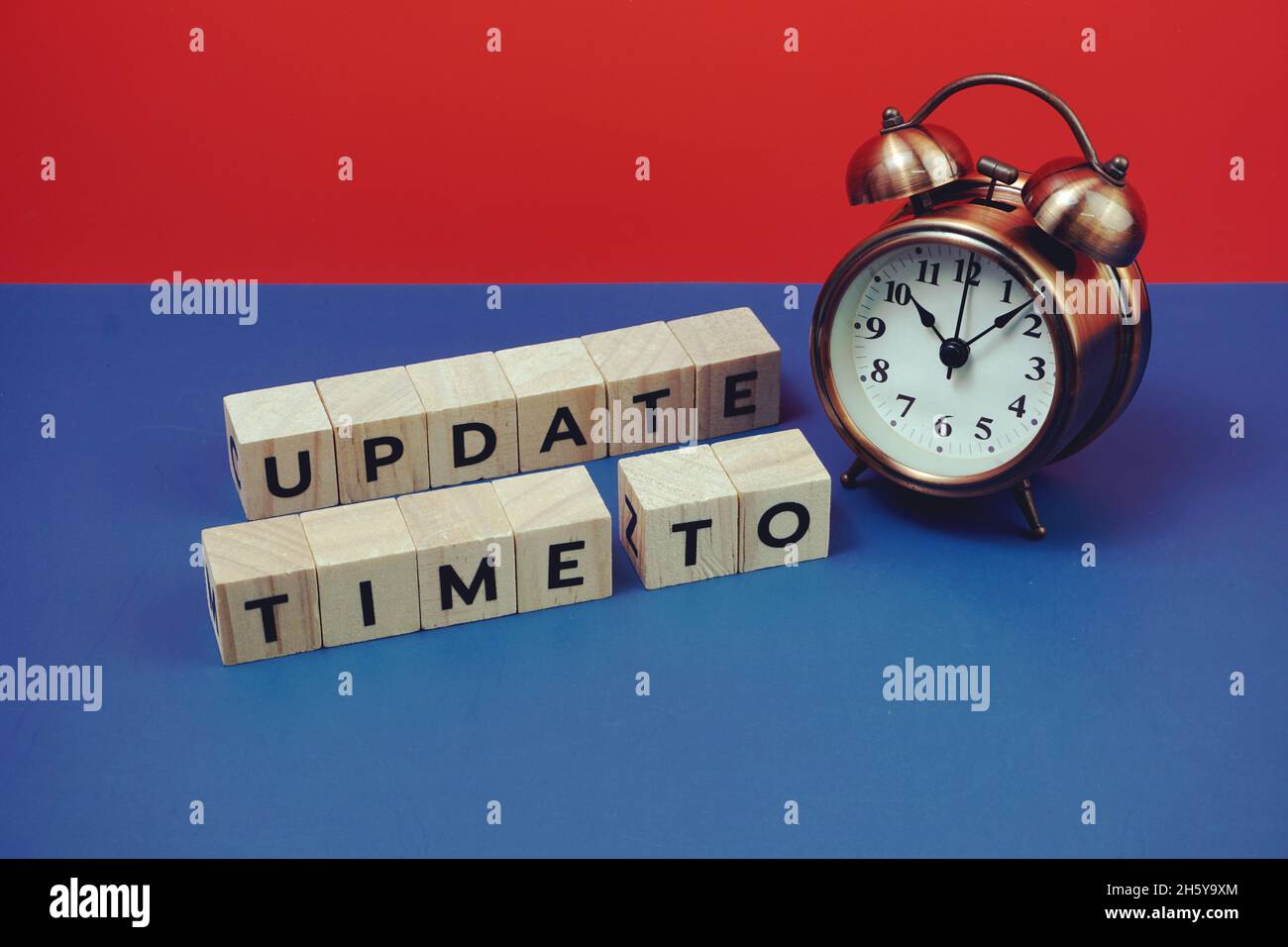 Time to Update alphabet letter with alarm clock on blue and red ...