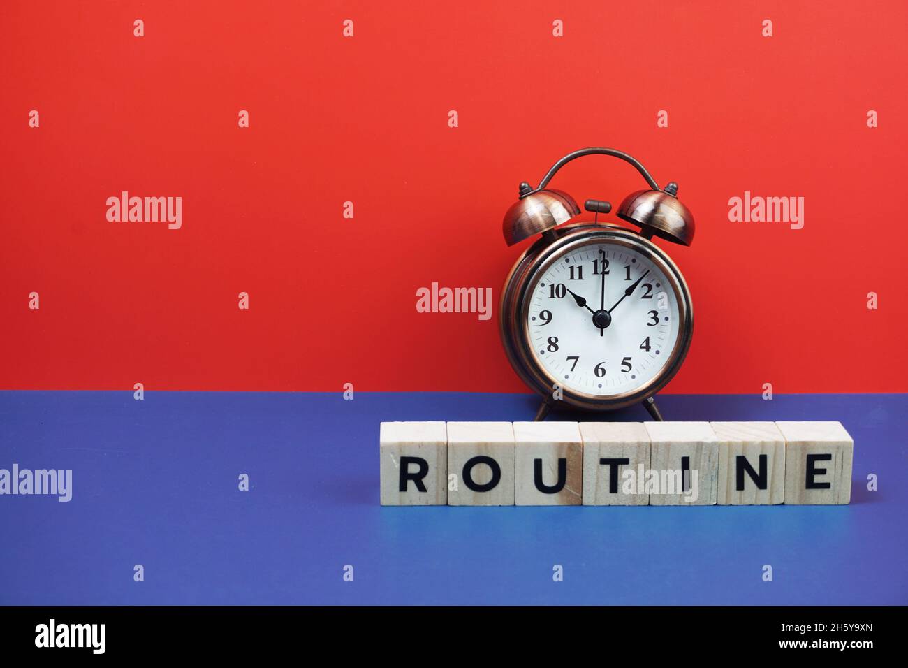 Routine alphabet letter with alarm clock on blue and red background ...