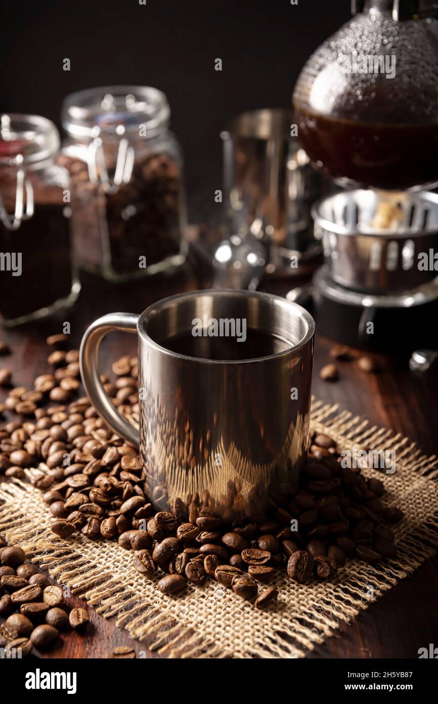 Metallic cup and vacuum coffee maker also known as vac pot, siphon or ...