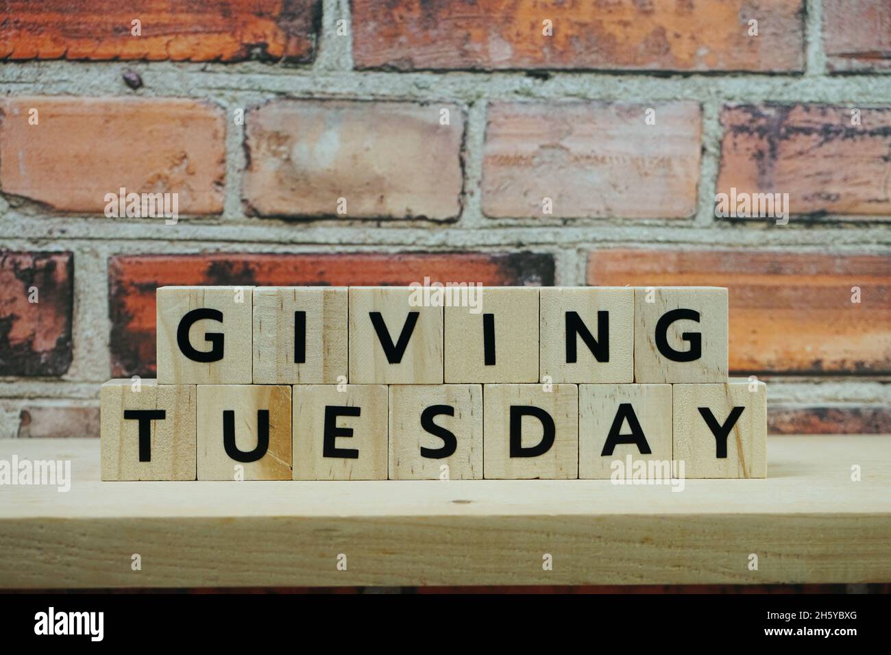 Giving Tuesday alphabet letter on wooden shelves background Stock Photo ...