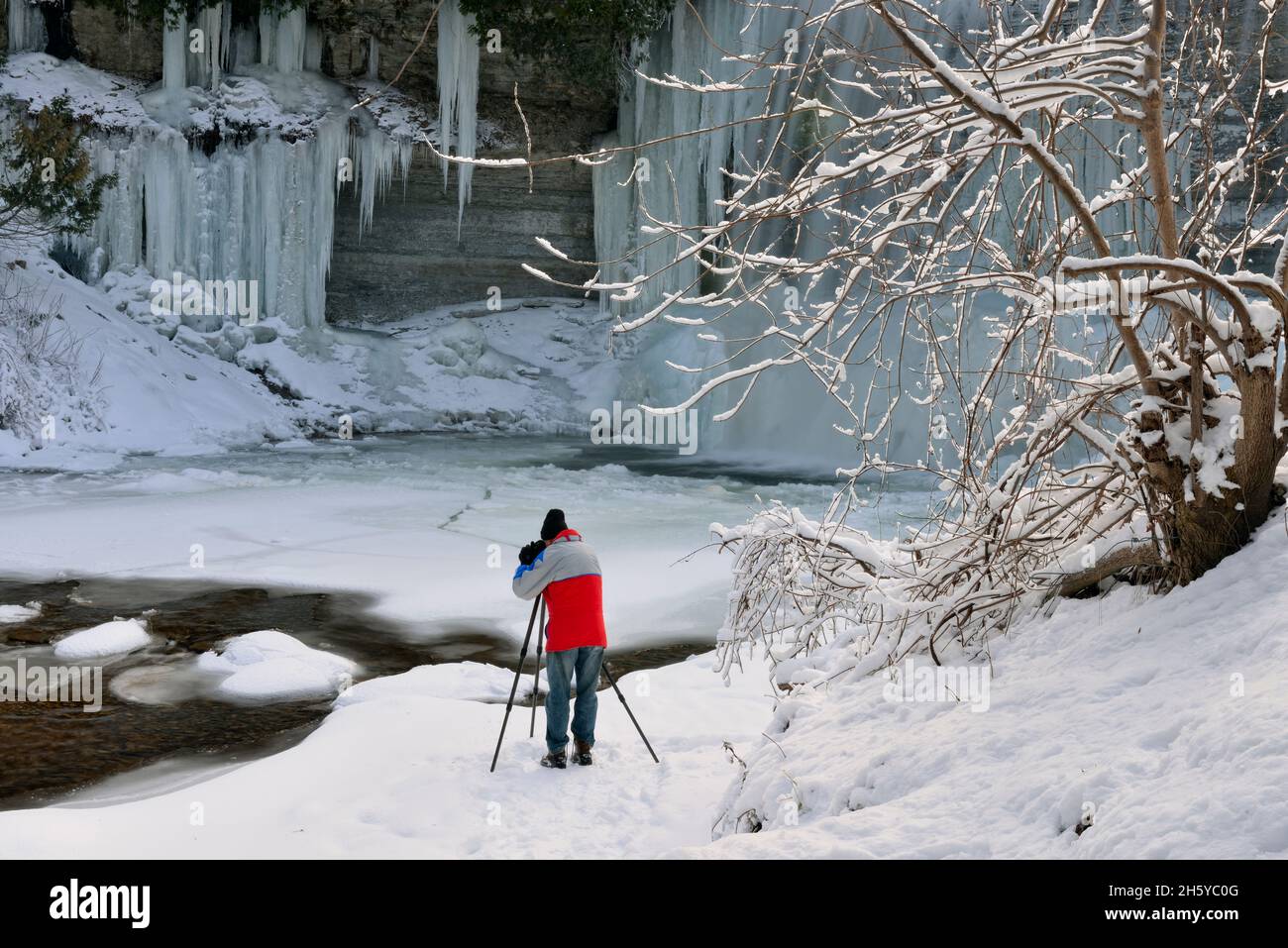 Photographer below Bridal Veil Falls and the Kagawong River in Winter ...