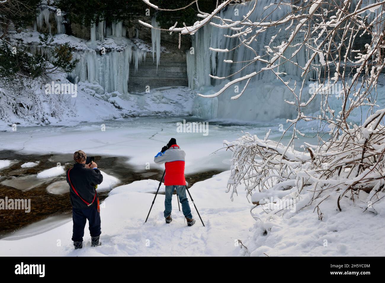 Photographer below Bridal Veil Falls and the Kagawong River in Winter ...