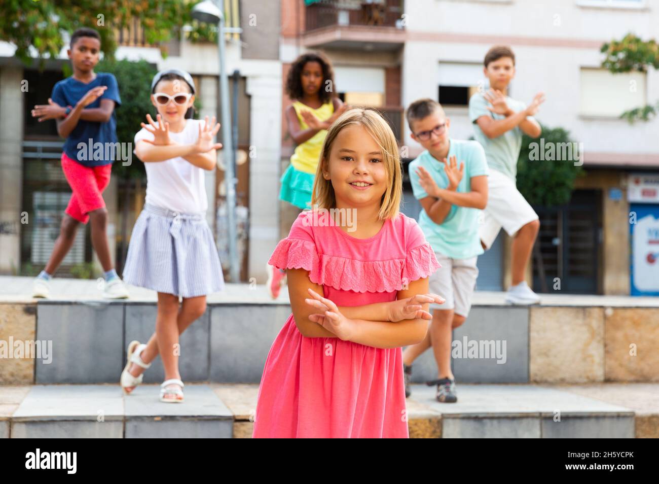 Group of kids performing street dance outdoors Stock Photo - Alamy