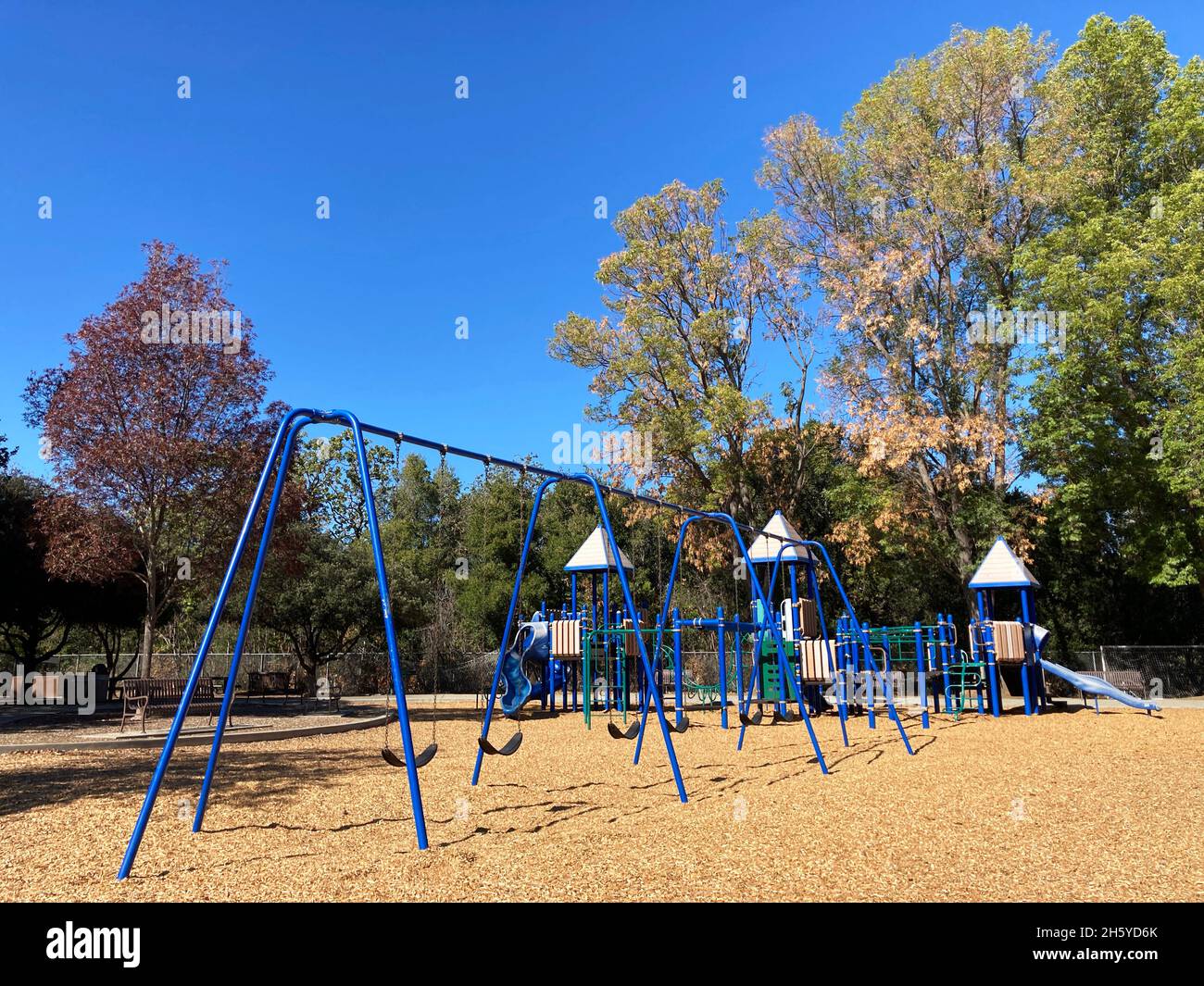 Empty children playground in the park under blue sky Stock Photo - Alamy