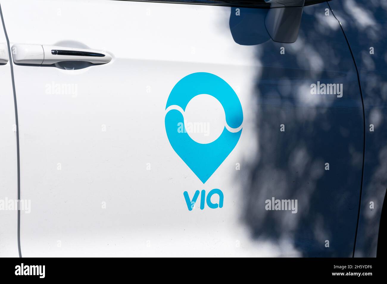 VIA logo, sign on on demand shuttle bus powered by Via Transportation ...
