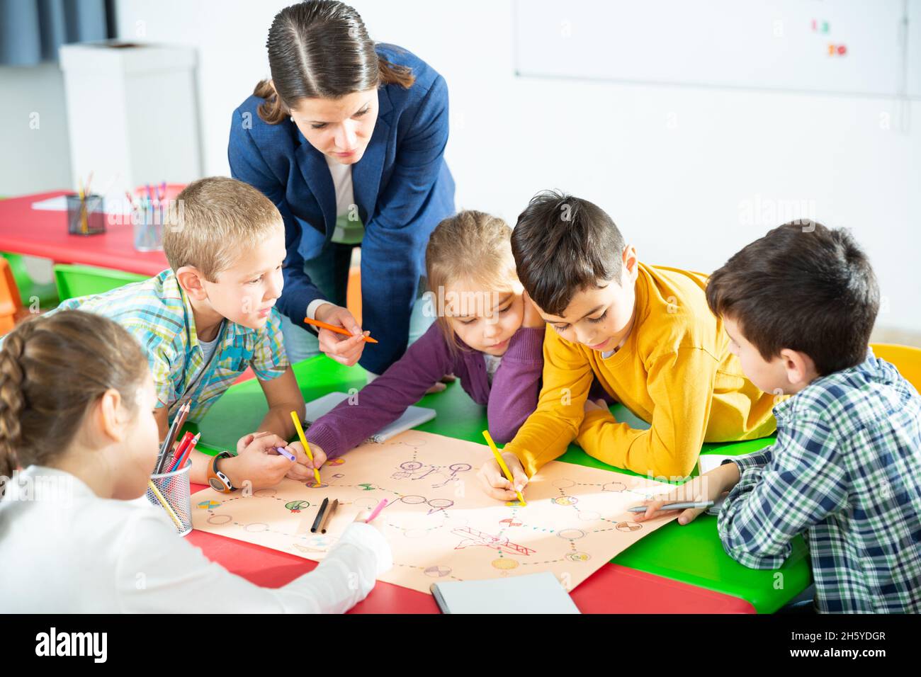 Kids with teacher playing educational tabletop game Stock Photo - Alamy Kids with teacher playing educational tabletop game Stock Photo - Alamy