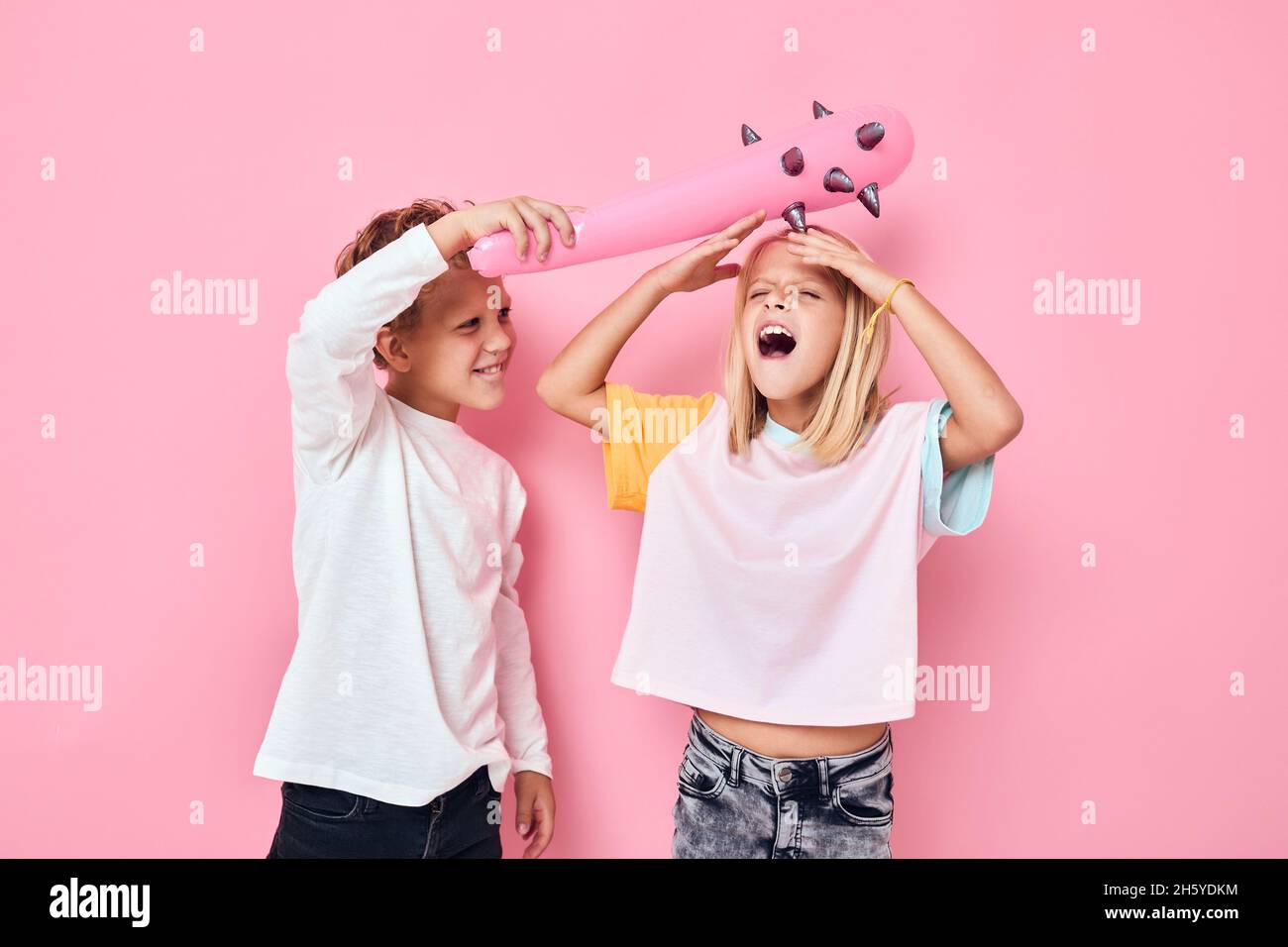 funny children play with a toy baton Stock Photo - Alamy
