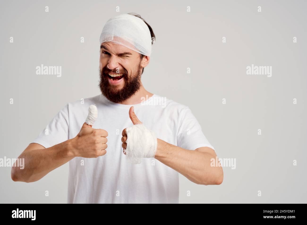 Man bandaged head and hand blood treatment Stock Photo - Alamy