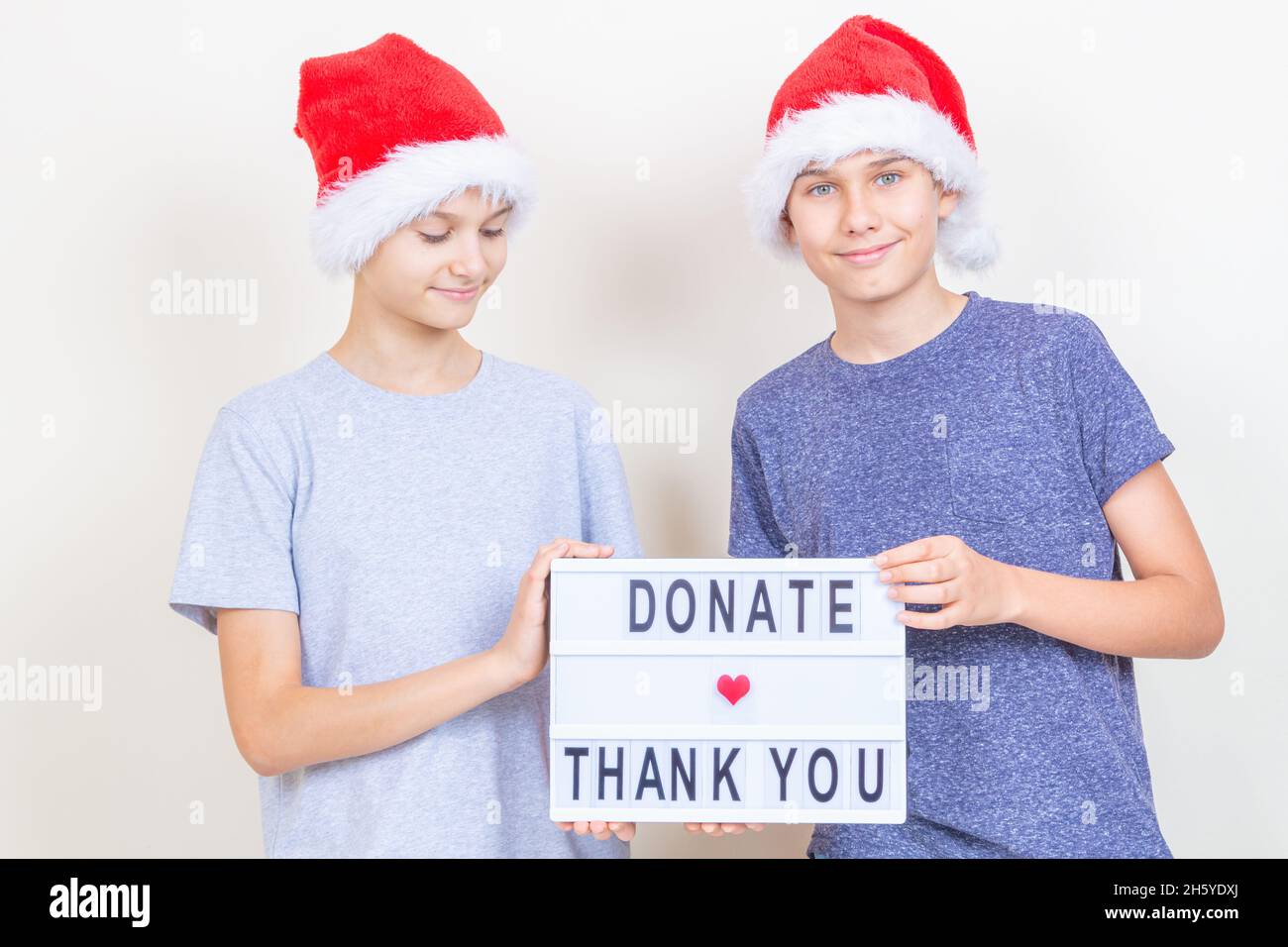Boy helping charity hi-res stock photography and images - Alamy