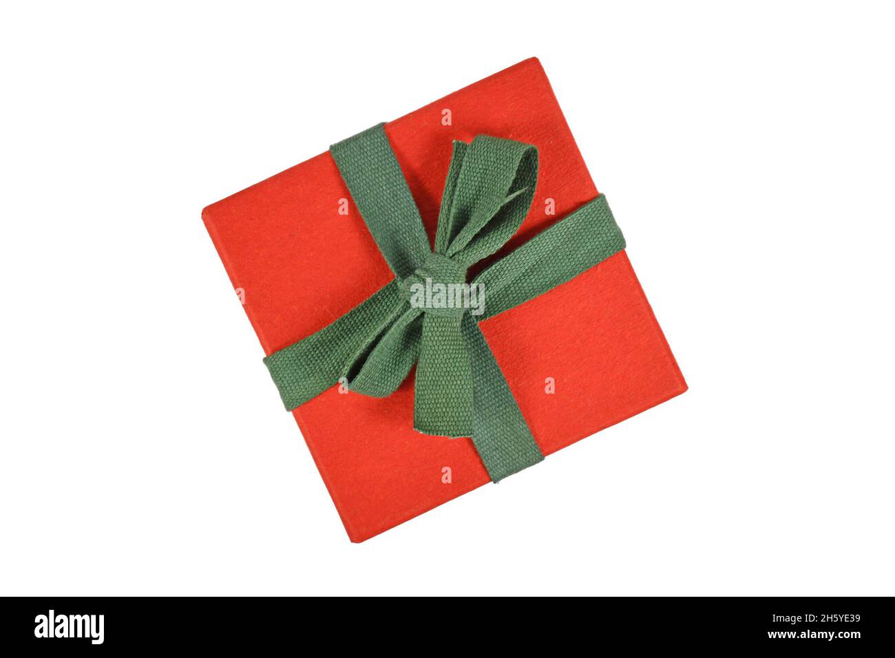 Top view of red Christmas gift box with green ribbon on white ...