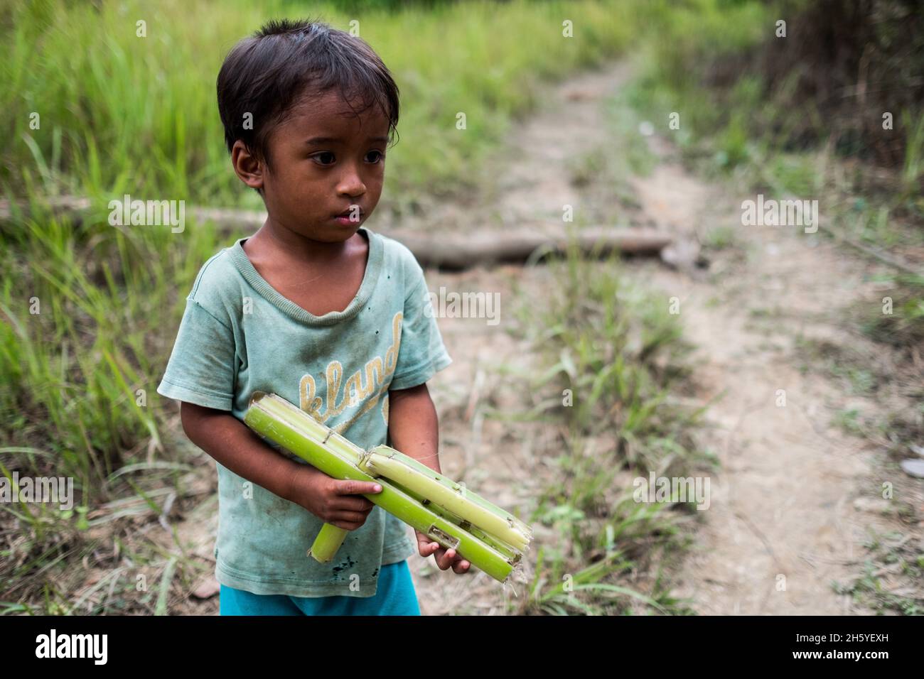 July 2017. Kid with a home-made toy gun. Kayasan, Barangay Tagabinet ...