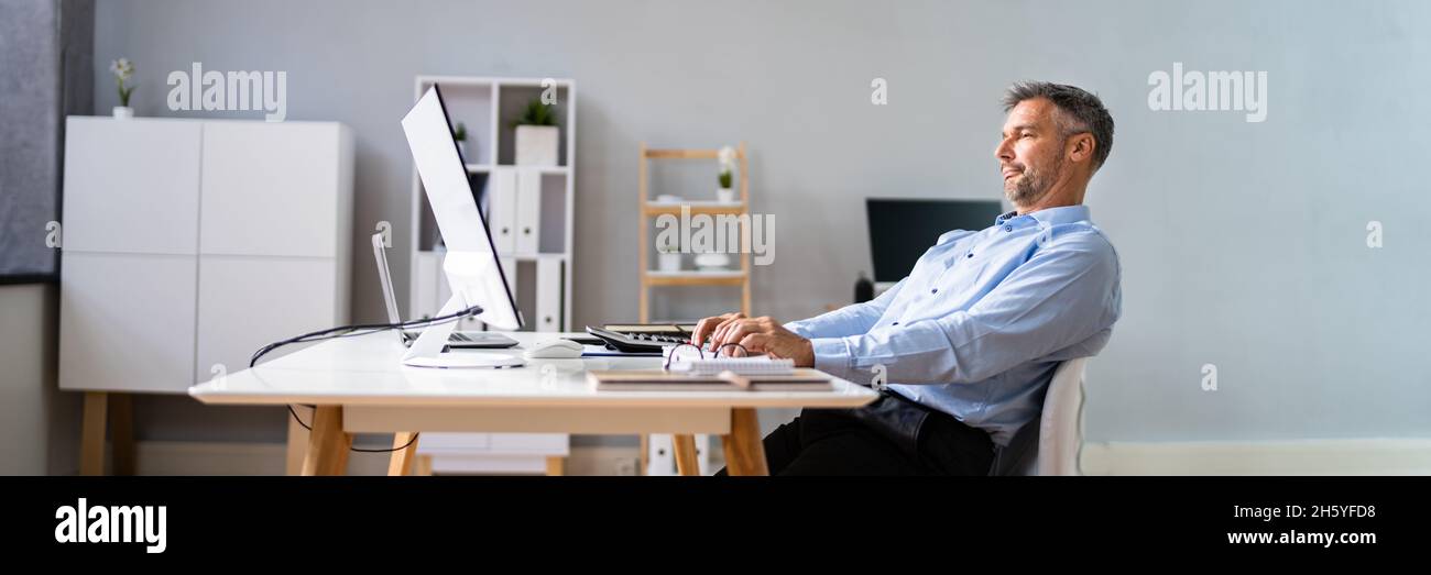 Man Sitting In Bad Posture Working On Computer In Office Stock Photo ...