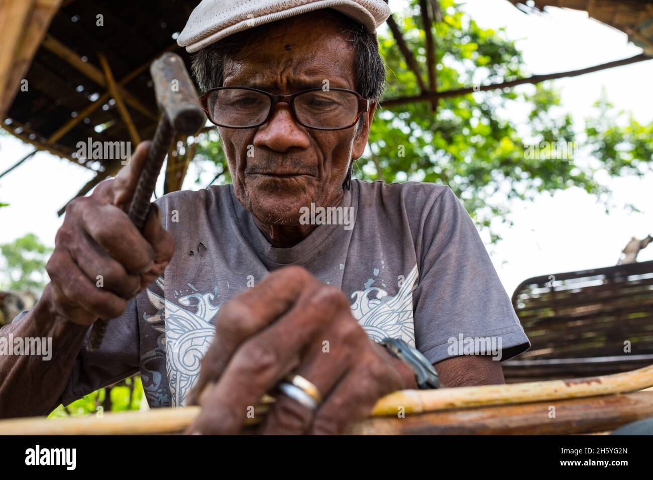 July 2017. Arenesto Deguen making an infant's walker from ratan. Local ...