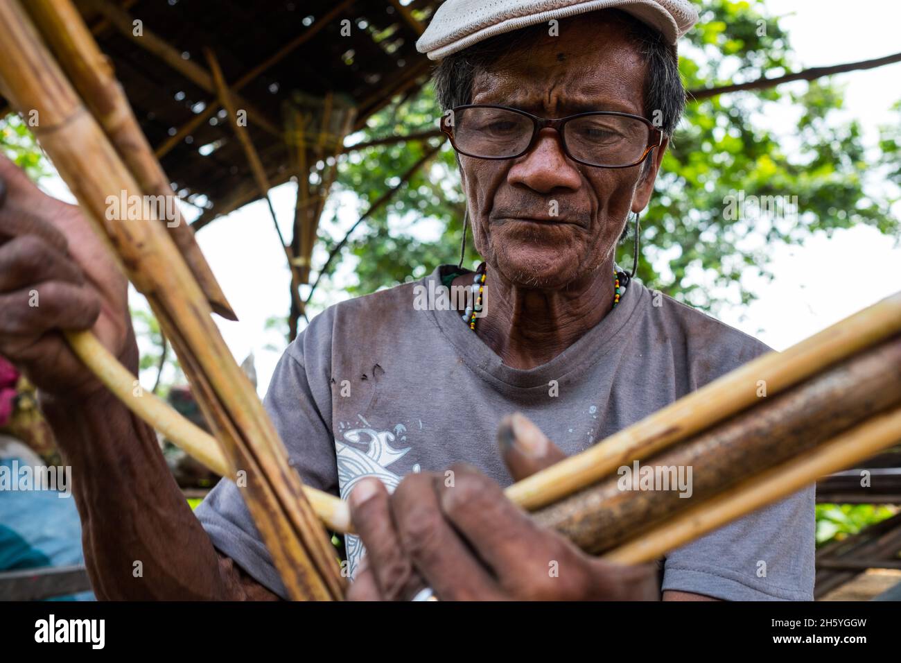 July 2017. Arenesto Deguen making an infant's walker from ratan. Local ...