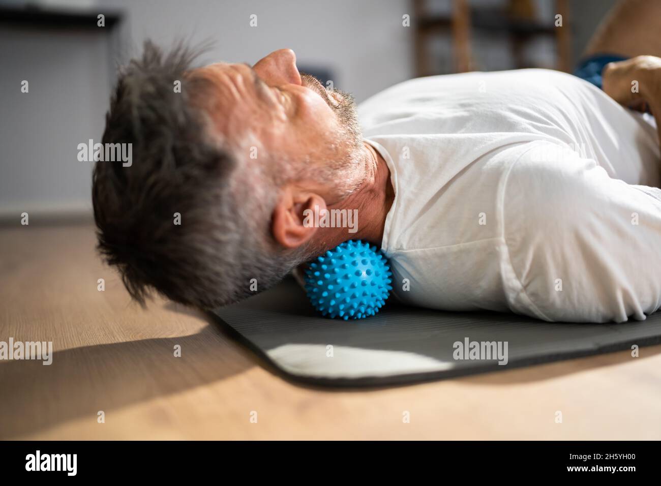 Neck Trigger Point Massage Using Spiky Ball Myofascial Release Stock