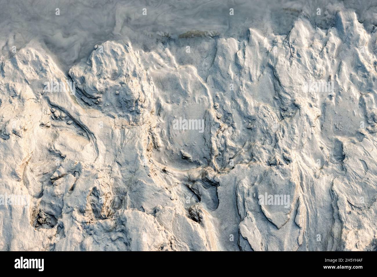 Wet sand on the river bank close up top view Stock Photo - Alamy
