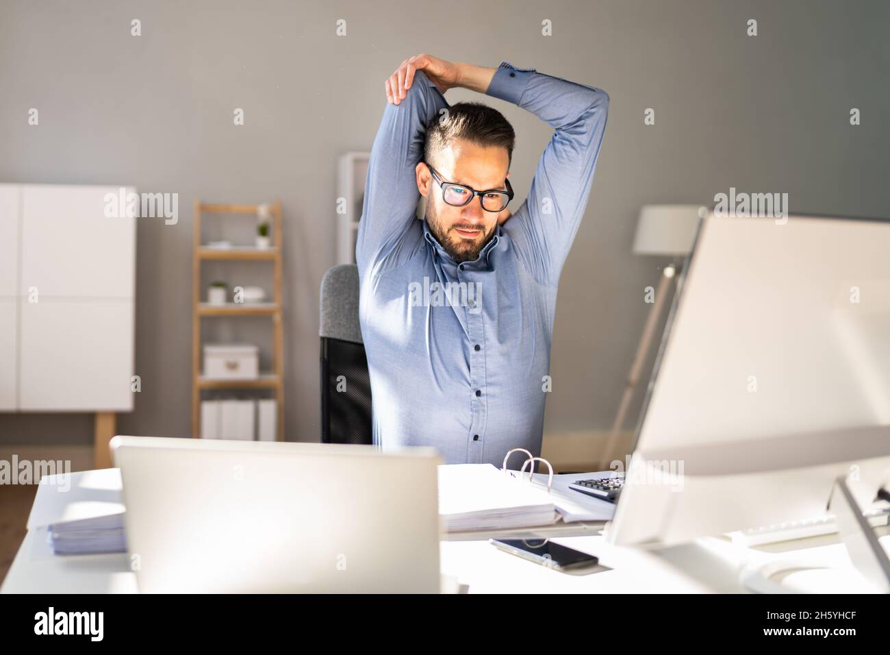 Stretch Exercise Workout At Office Business Desk Stock Photo - Alamy