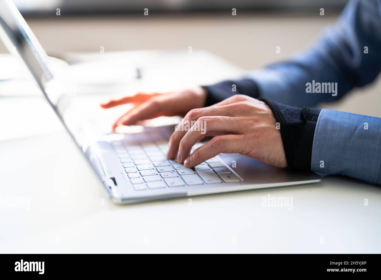 Pain Relief Bandage And Wrist Strap. Typing On Keyboard Stock Photo - Alamy
