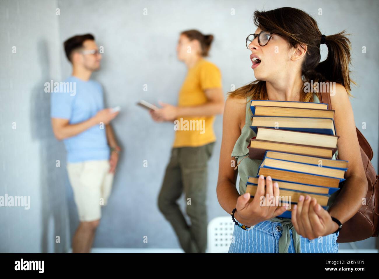 Eager student overwhelmed by studying and reading books Stock Photo - Alamy