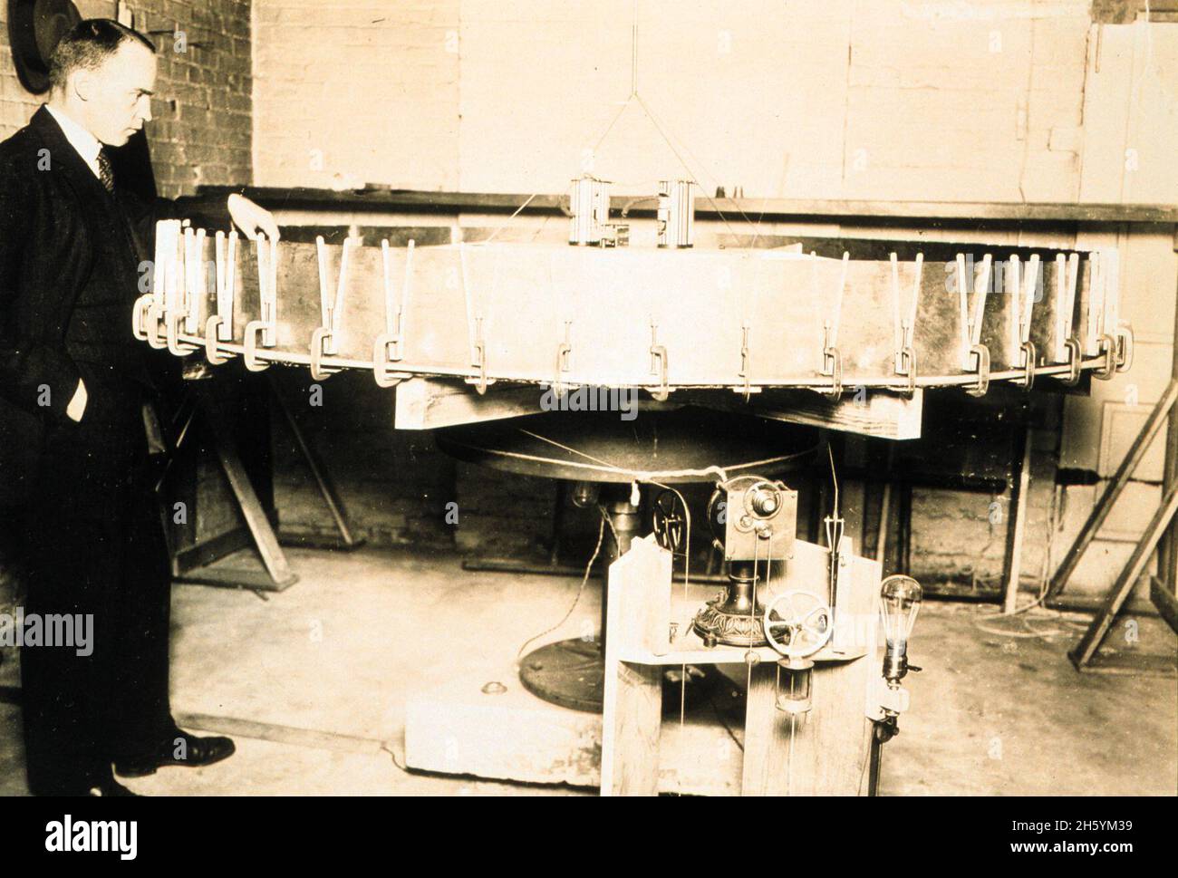 Meteorologist Carl-Gustaf Rossby standing beside his rotating tank ...