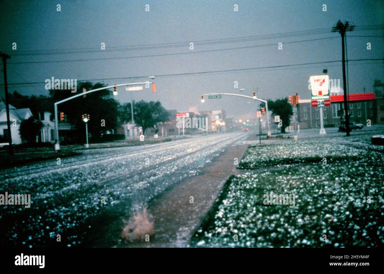 Large hail collects on streets and grass during severe thunderstorm ...