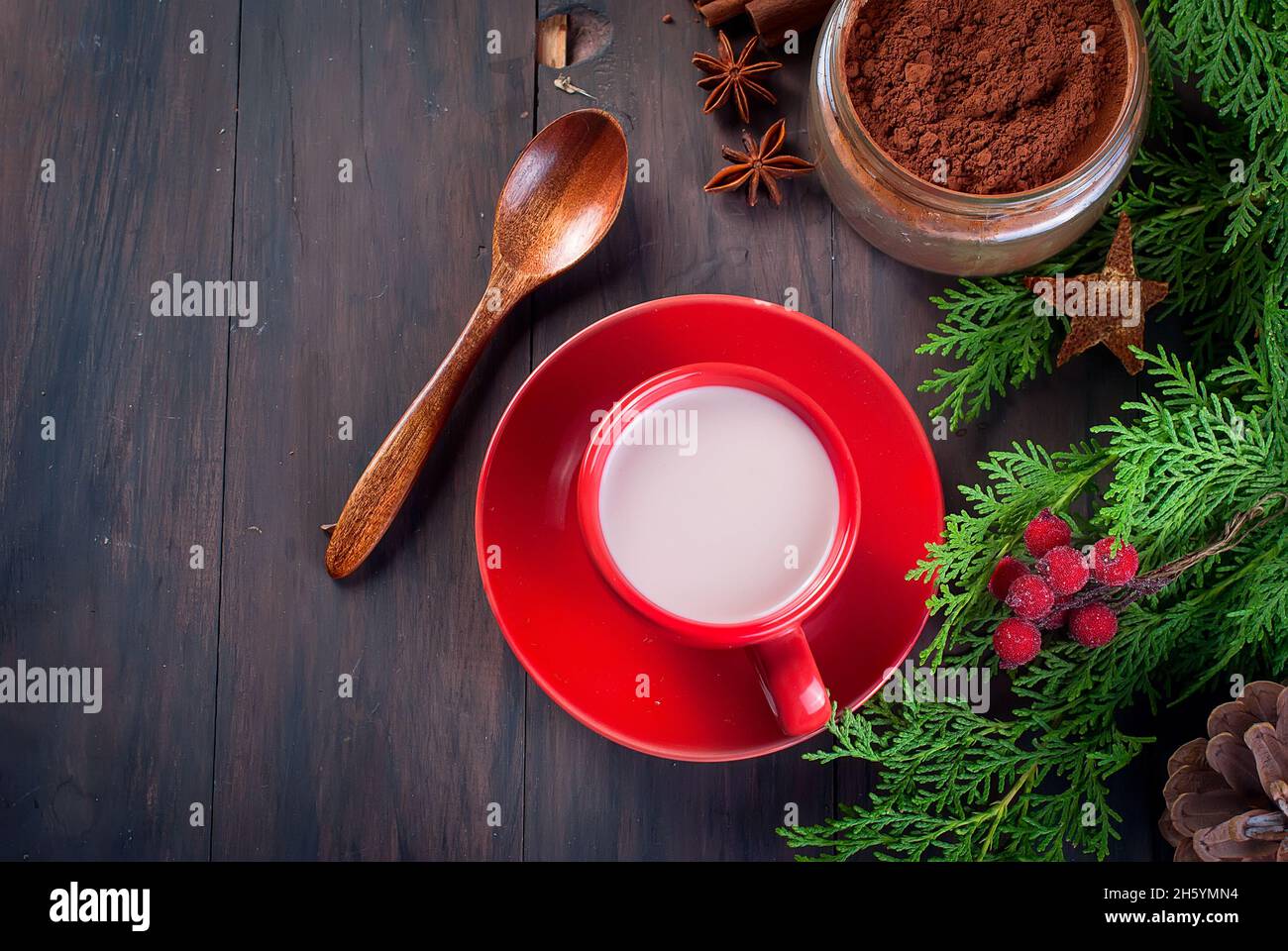 Christmas traditional hot drink cocoa in red cup, cocoa powder in a jar ...