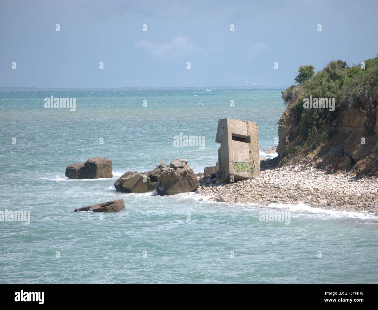 World war II bunker ruins consumed by by the time and the ocean waves ...