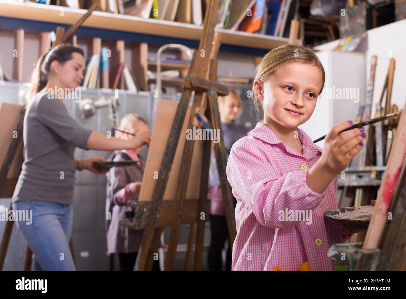 schoolgirls diligently training their painting skills during class at ...