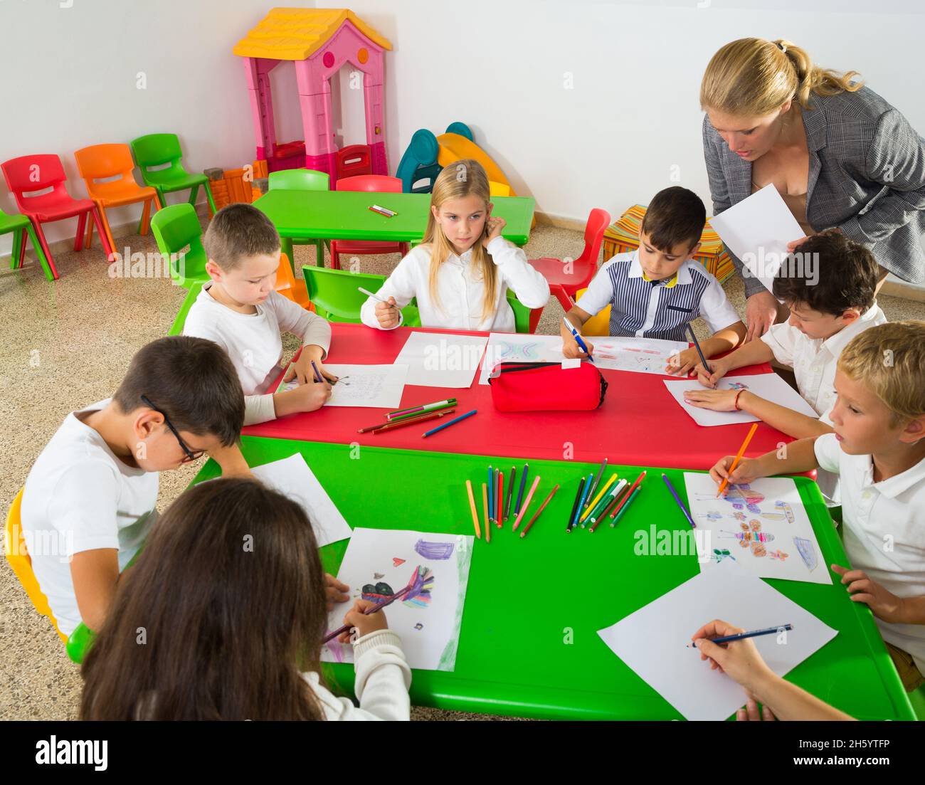 School kids studying in classroom with teacher Stock Photo - Alamy