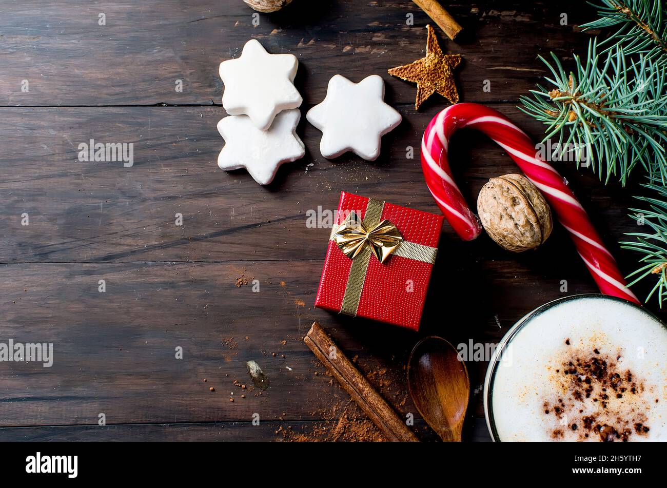 cup of hot cocoa or hot coffee latte with cinnamon, fir tree and ...