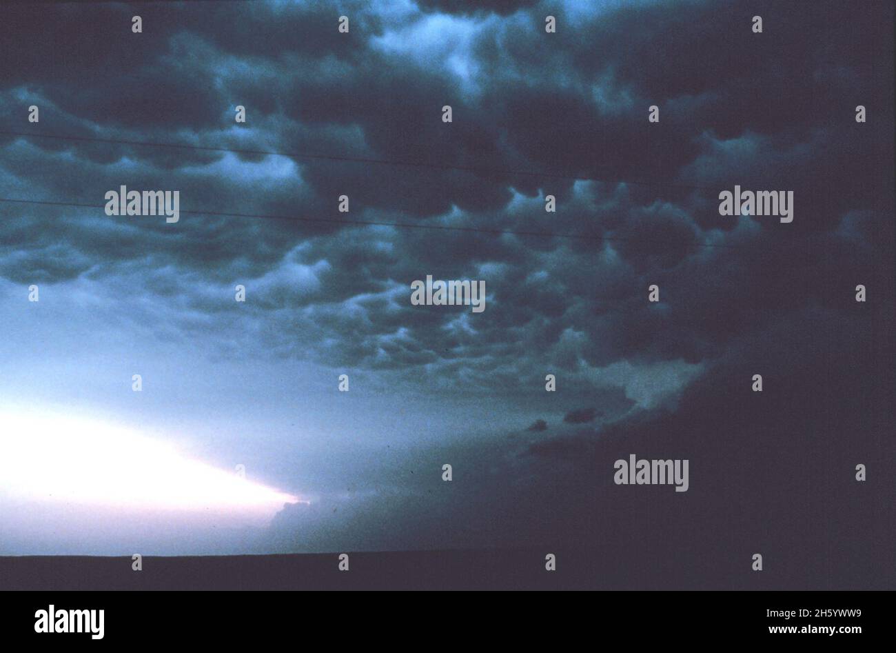 Cumulonimbus capillatus incus mamma. Mammatus clouds visible under the ...
