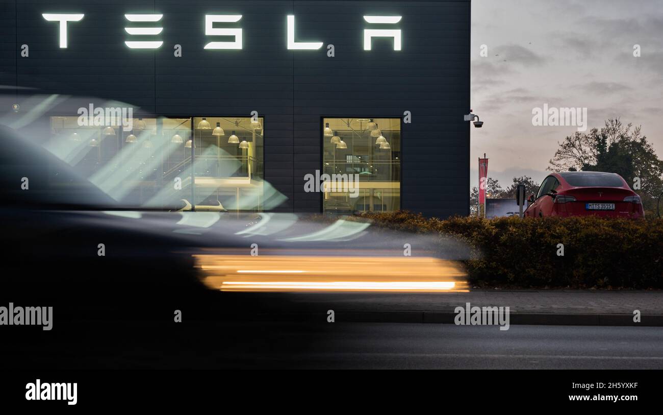 Hanover, Germany. 12th Nov, 2021. Cars drive past a dealership of the ...