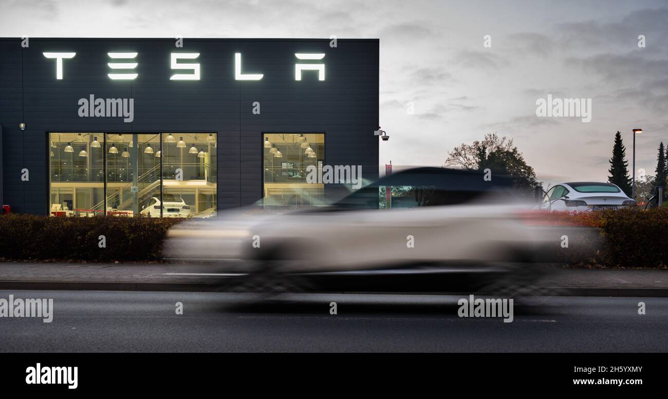 Hanover, Germany. 12th Nov, 2021. Cars drive past a dealership of the ...