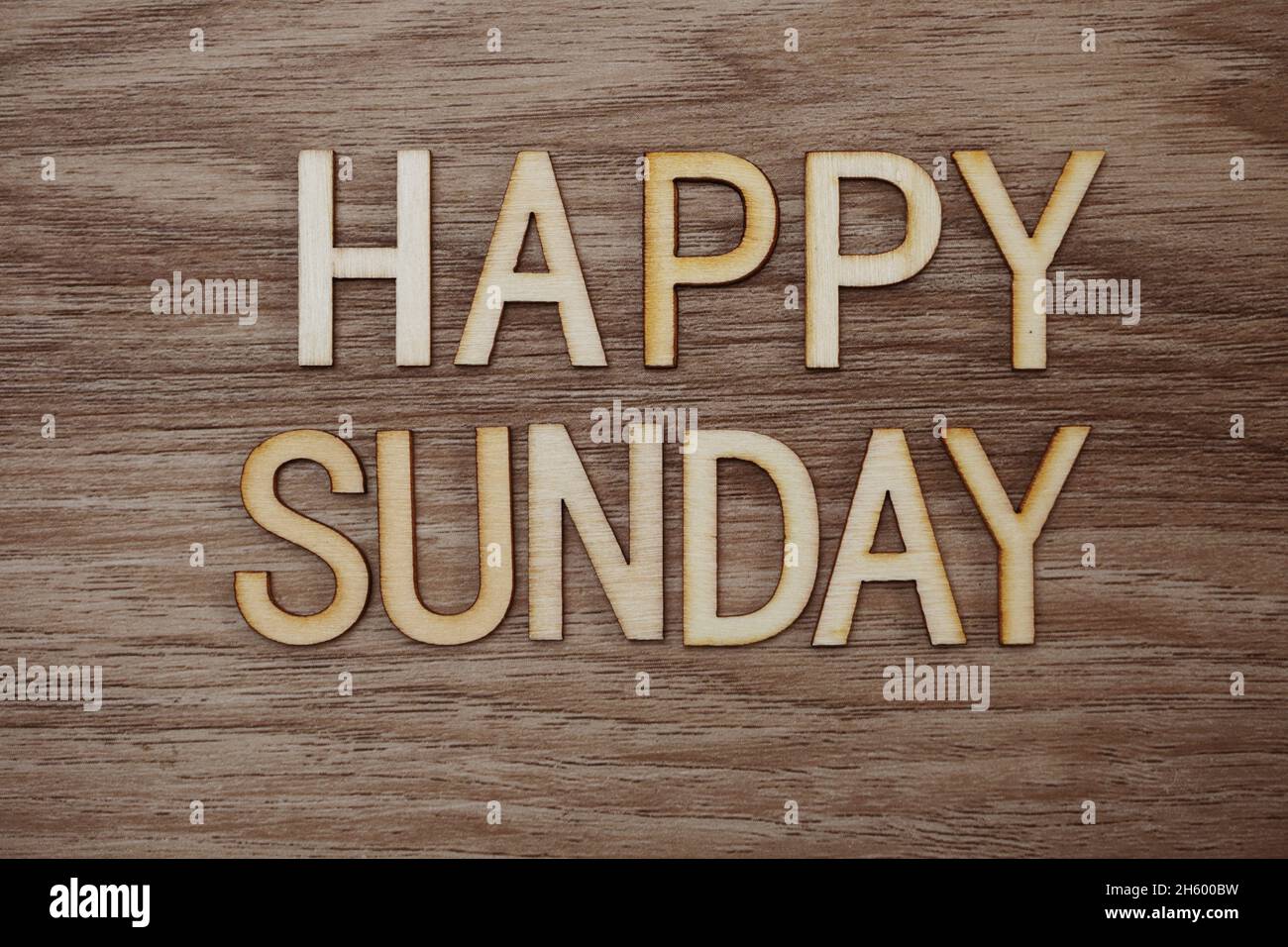 Happy Sunday text message on wooden background Stock Photo - Alamy
