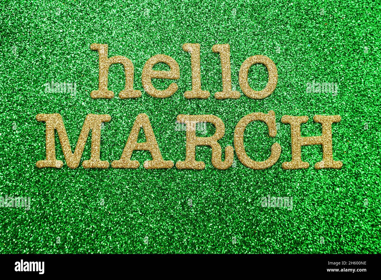 Hello March alphabet letters on green glitter background Stock Photo ...