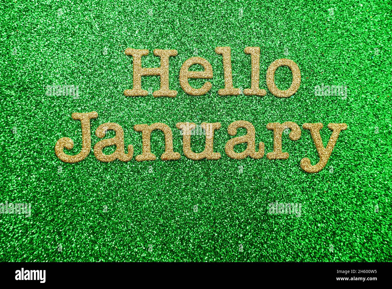 Hello January alphabet letters on green glitter background Stock Photo ...
