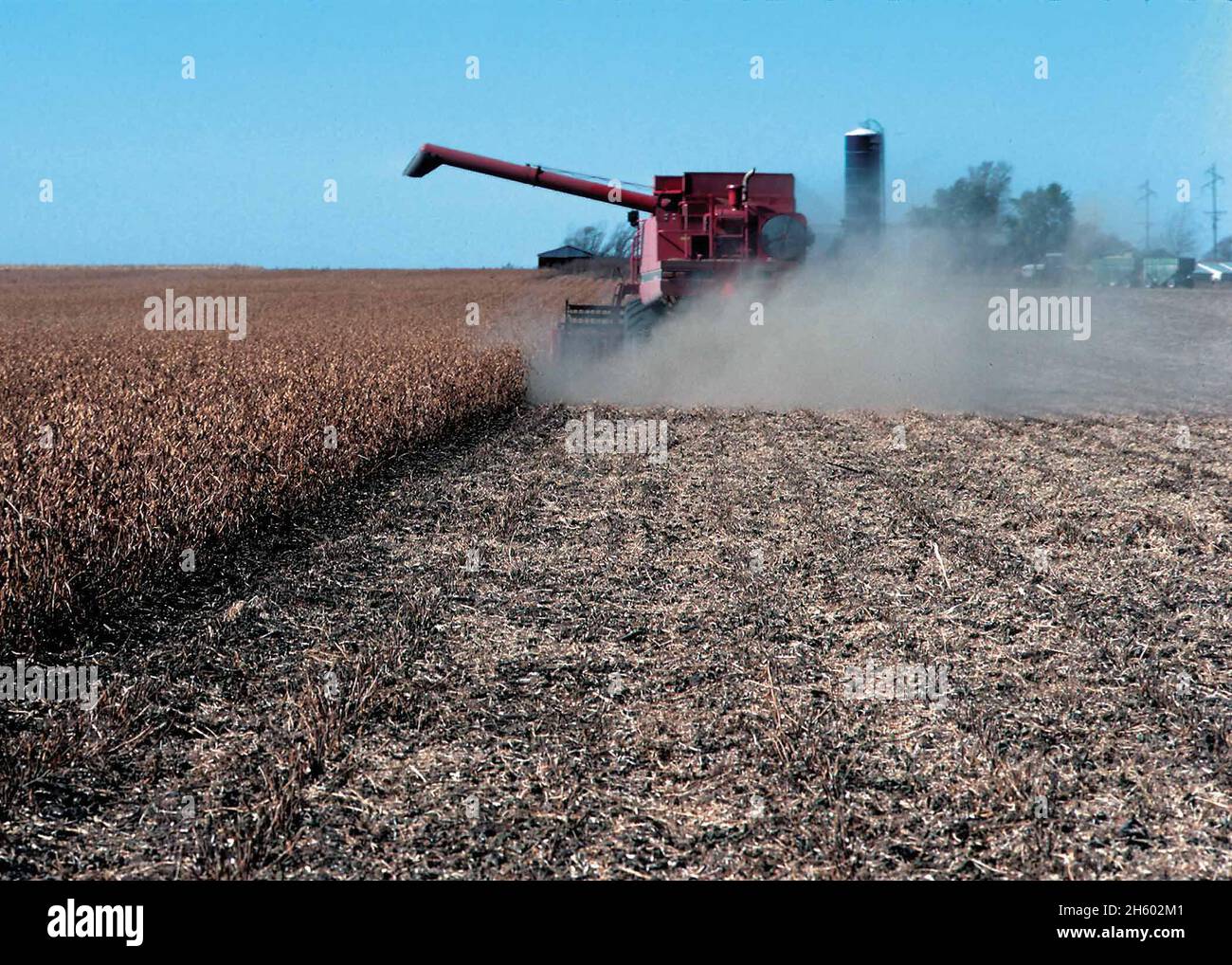 A farmer in his combine harvesting his a field ca. 2011 or earlier ...