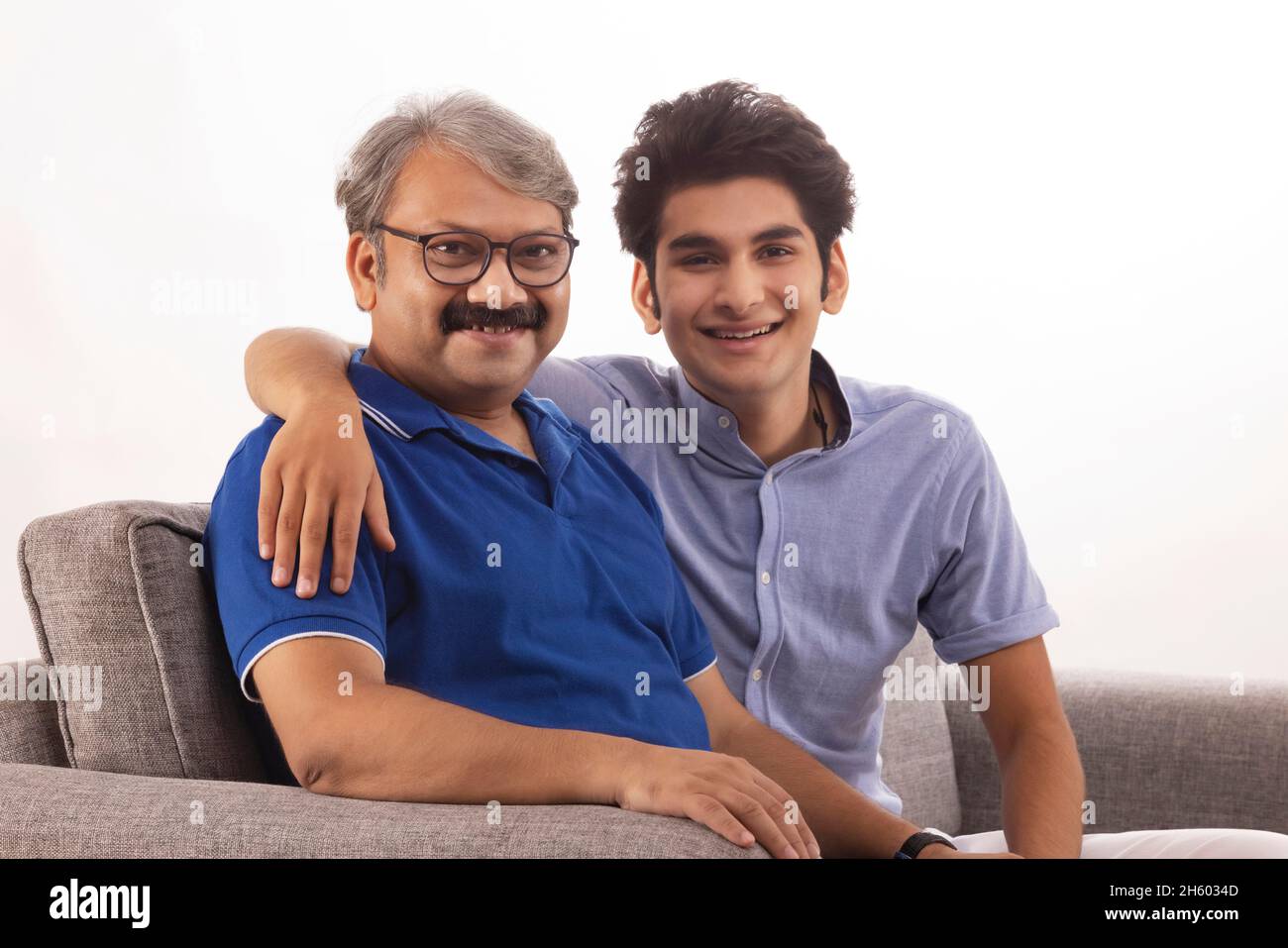 Indian father and son posing together with smiling face in front of ...