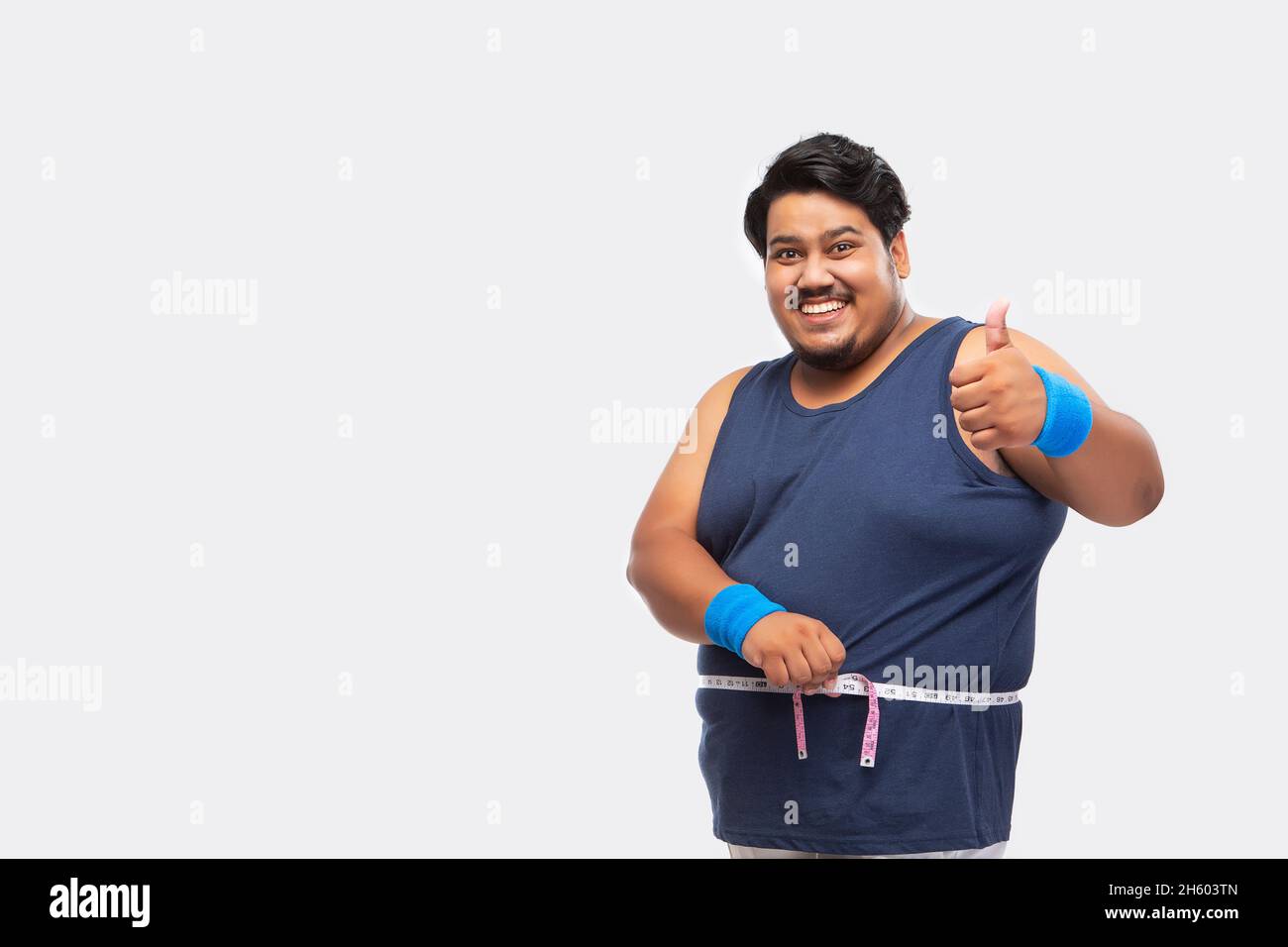 Portrait of a fat man smiling showing thumbs up while wrapping ...