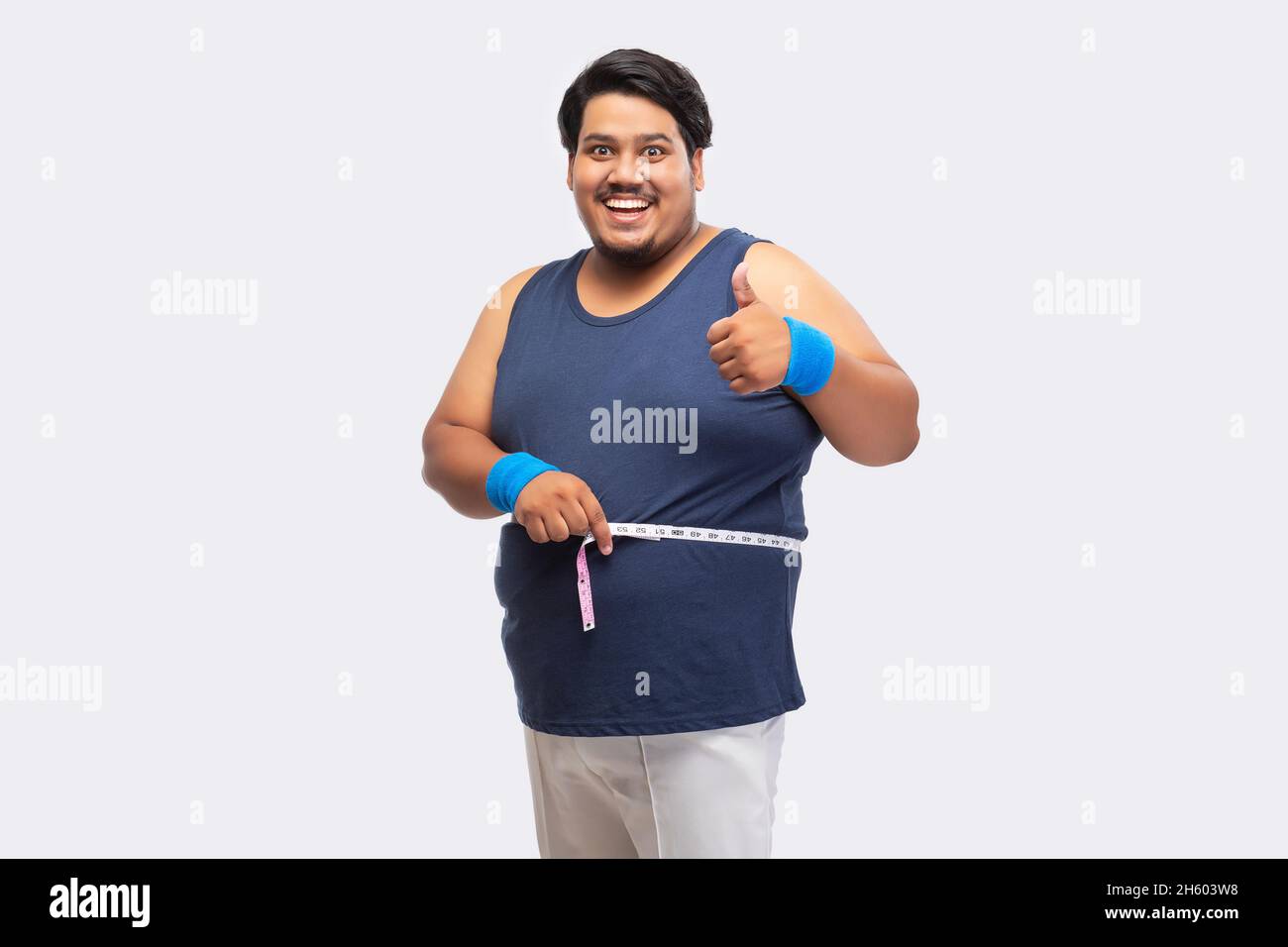 Portrait of a fat man smiling showing thumbs up while wrapping ...